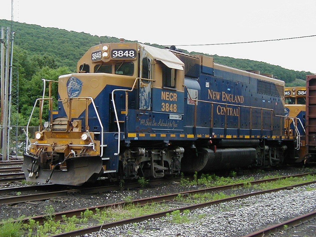NECR 3848 starts a freight train moving thru the yard after a short stop for a crew change